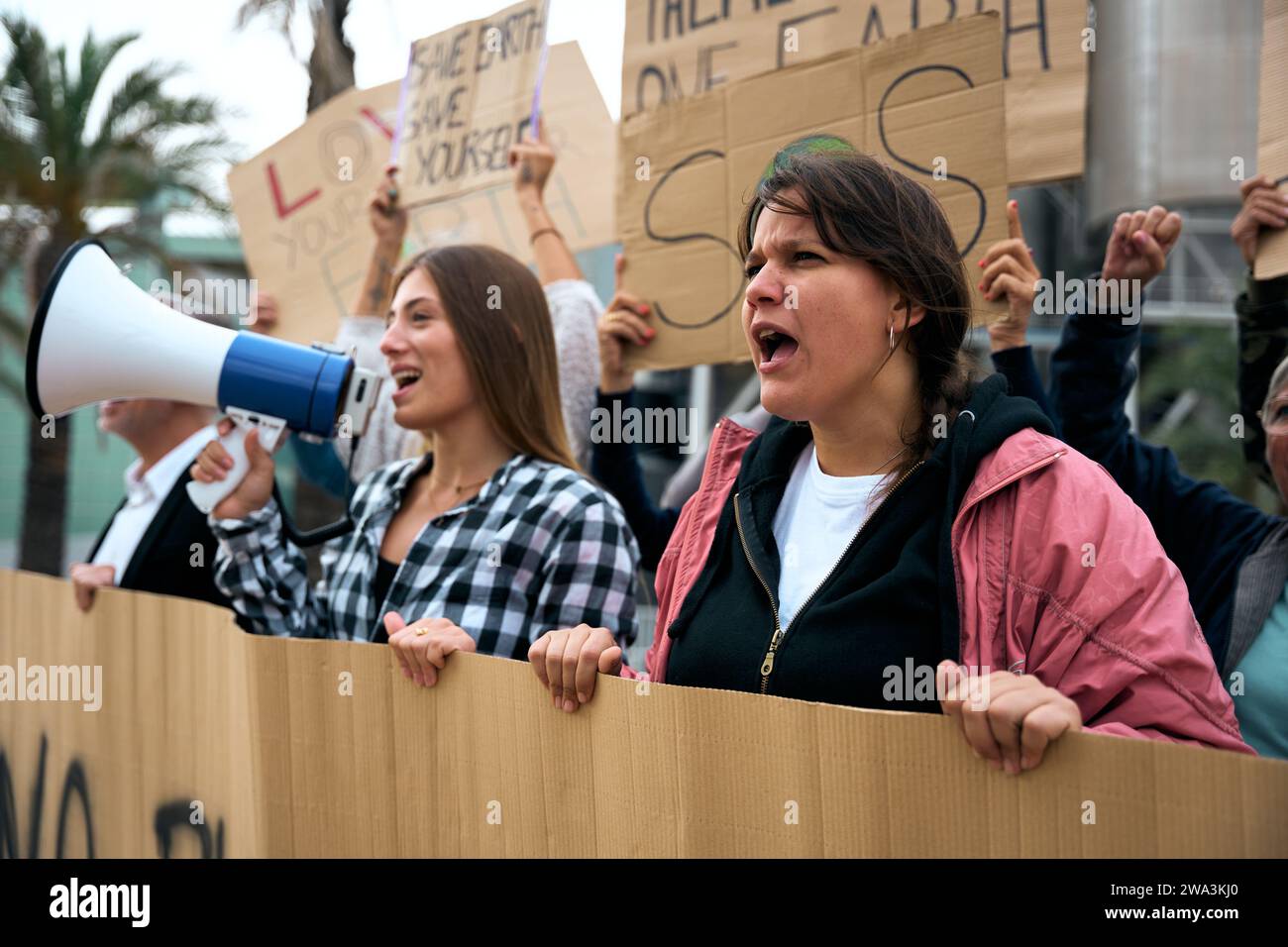 Angry and rebellious woman speaking and protesting with megaphone at ...