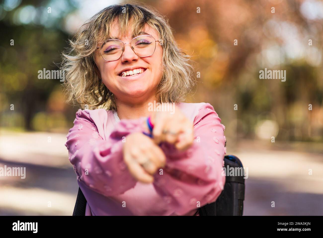 Young woman with cerebral palsy disability on wheelchair greeting and ...