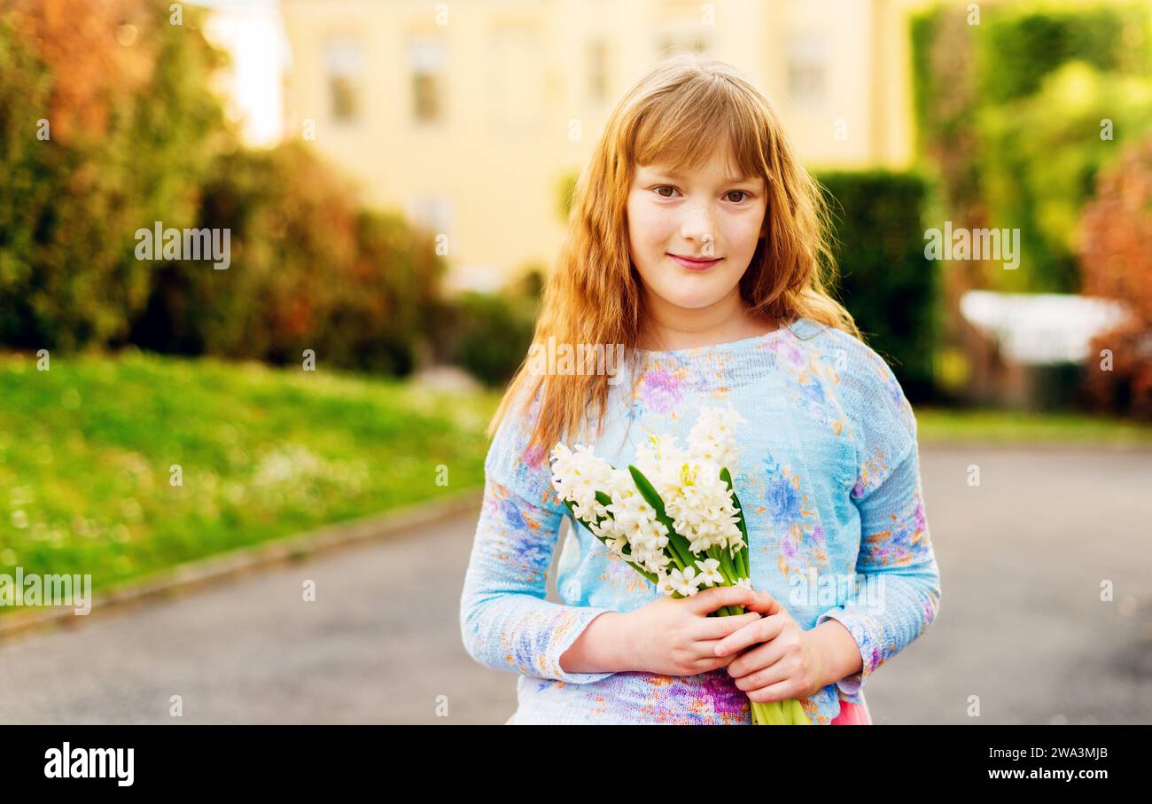 Outdoor sunny portrait of a kid girl with white Hyacinth flowers Stock ...