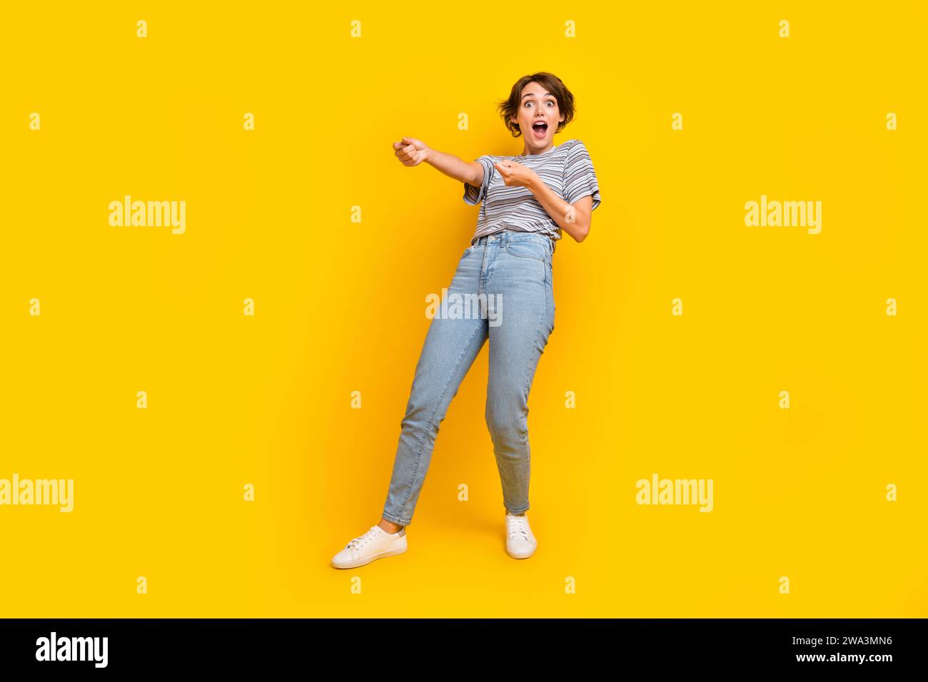 Full size portrait of astonished girl arms pull empty space rope string ...