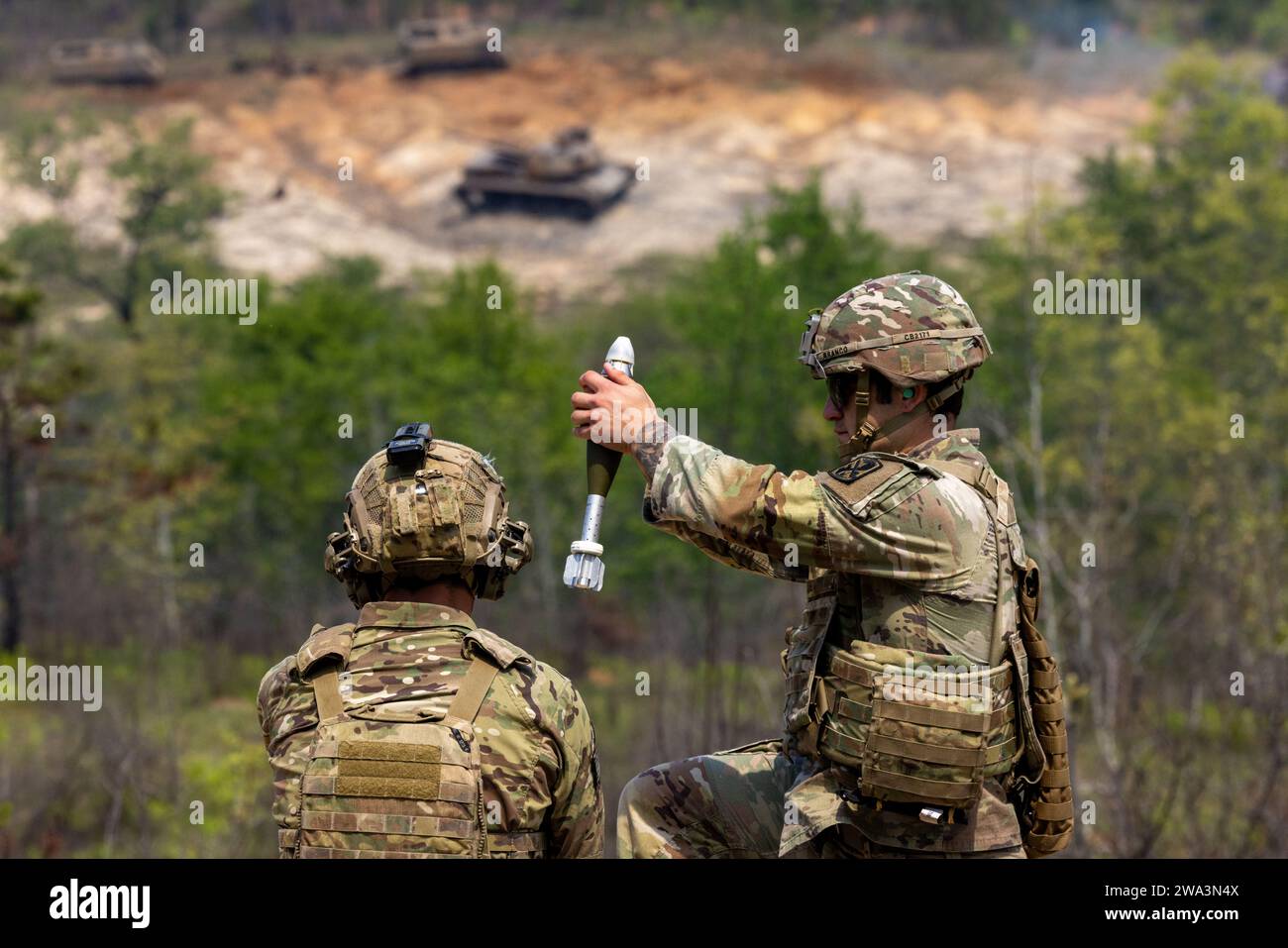 U.S. Army Soldiers aim and fire a handheld and bipod-stabilized 60mm ...