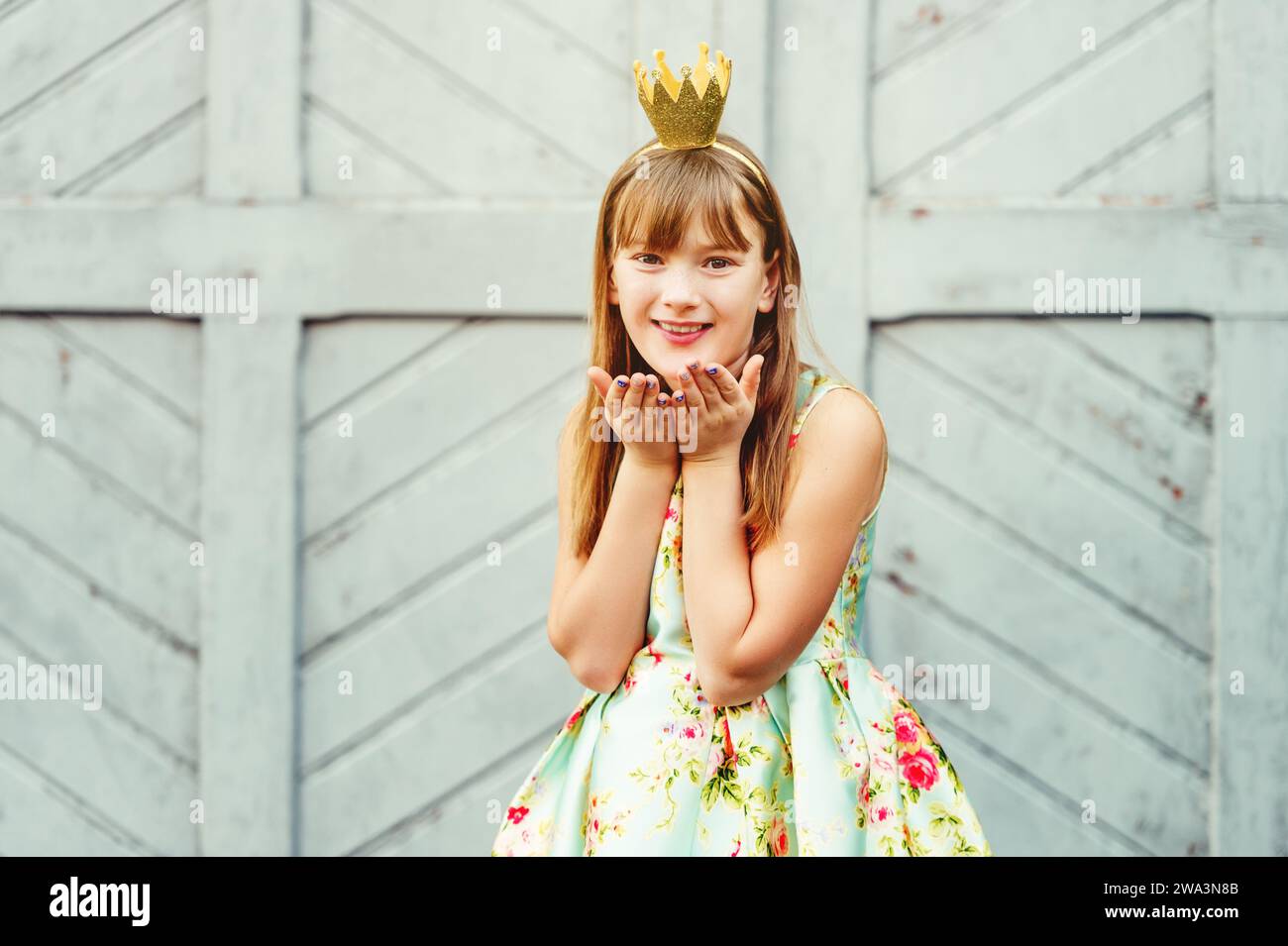 young little 9-10 year old girl, wearing beautiful dress and gold crown ...