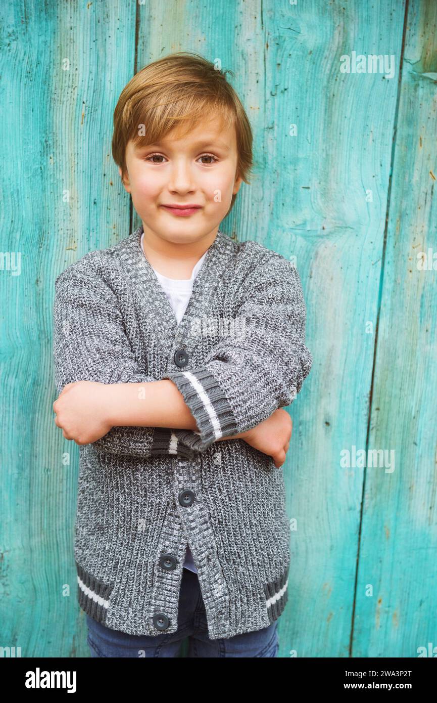5-6 year old kid boy posing outdoors, wearing grey knitted cardigan ...
