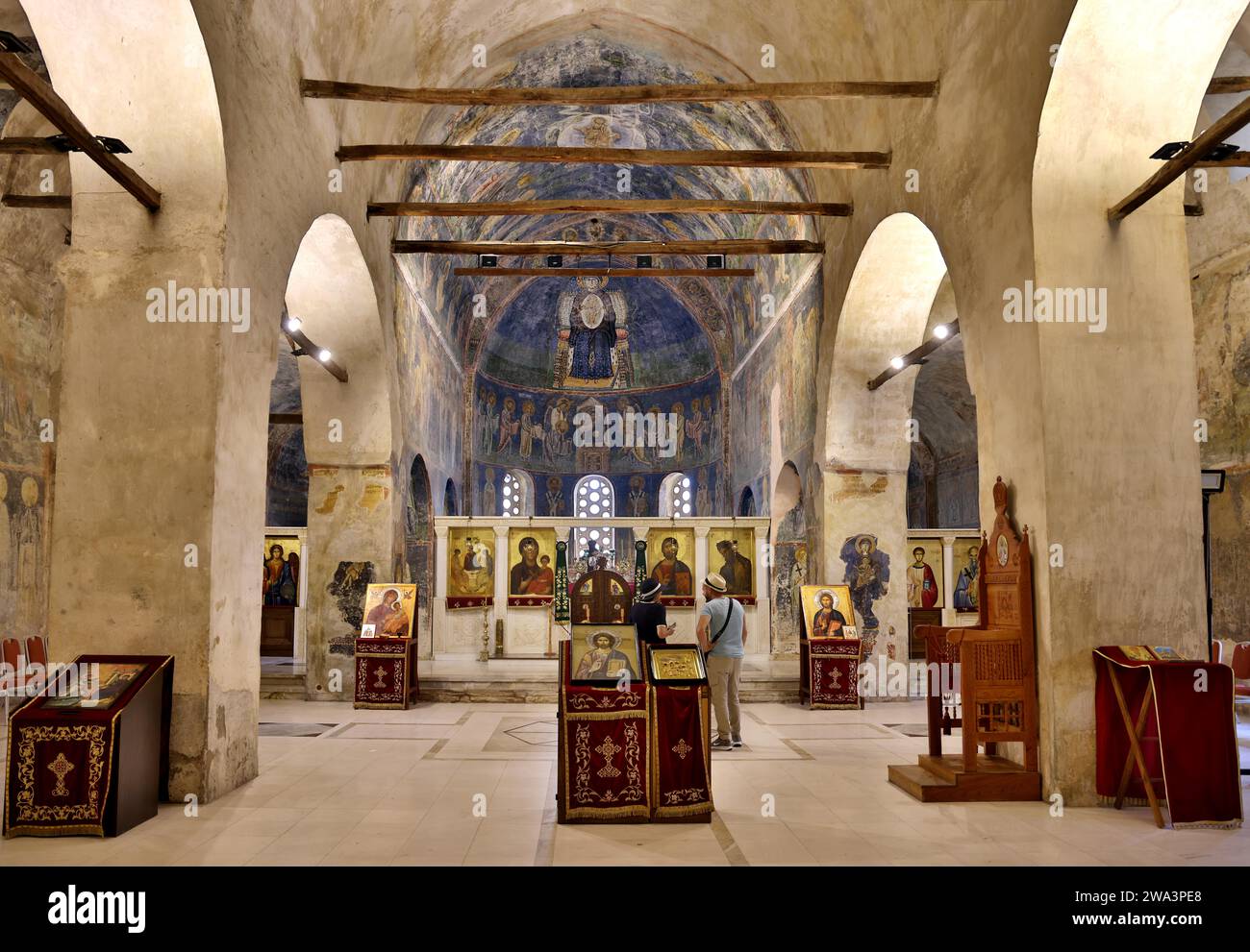 Two visitors admire the interior of the Orthodox Church of St Sophia in Ohrid, iconostasis ...