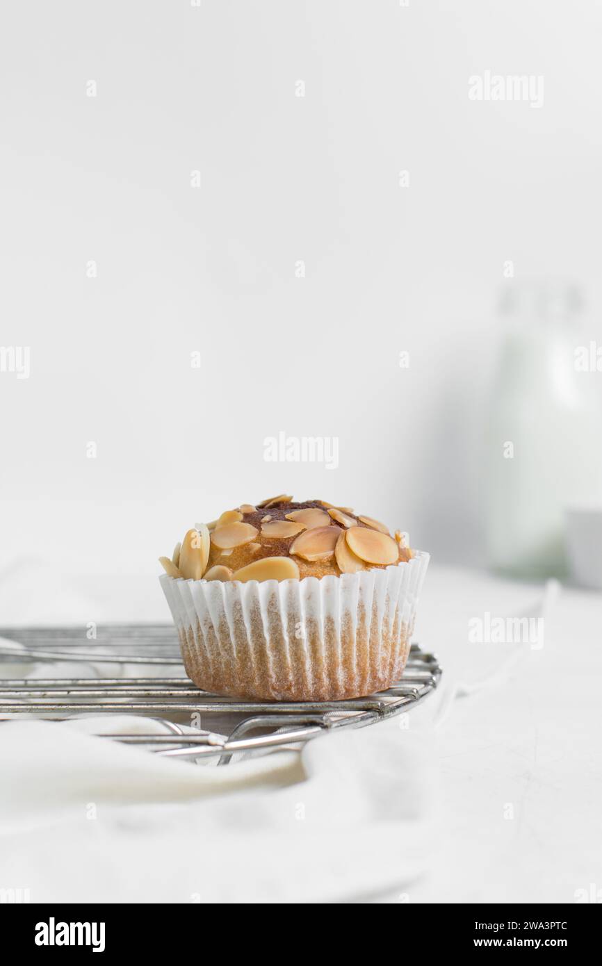 vanilla almond muffins on a silver cooling rack, homemade bakery style ...