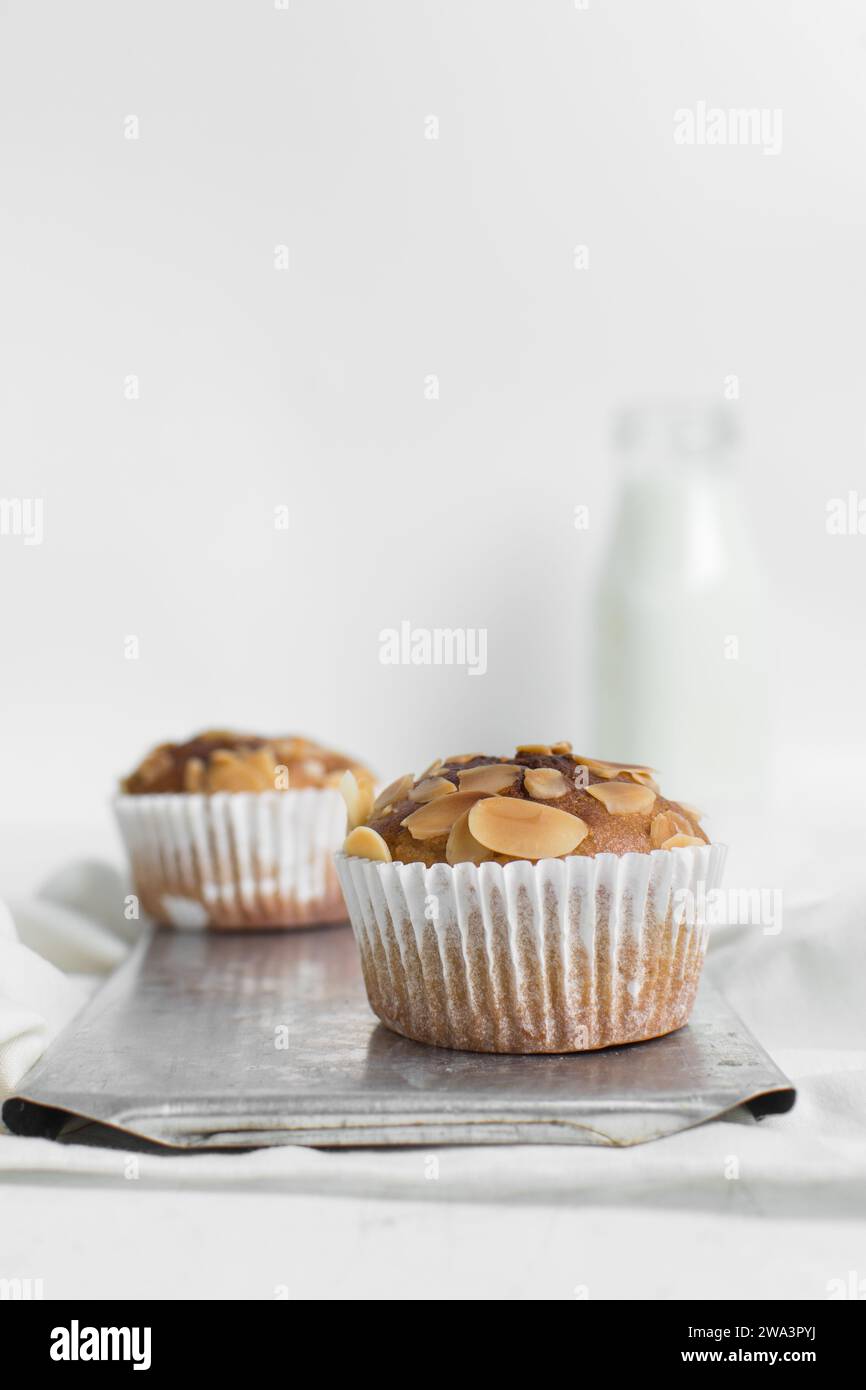 vanilla almond muffins on a silver cooling rack, homemade bakery style ...