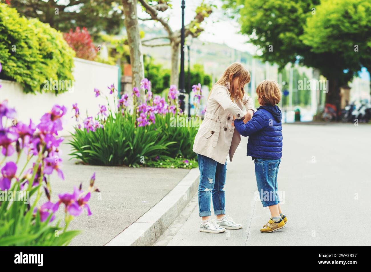 Two funny and happy kids playing together outdoors Stock Photo - Alamy