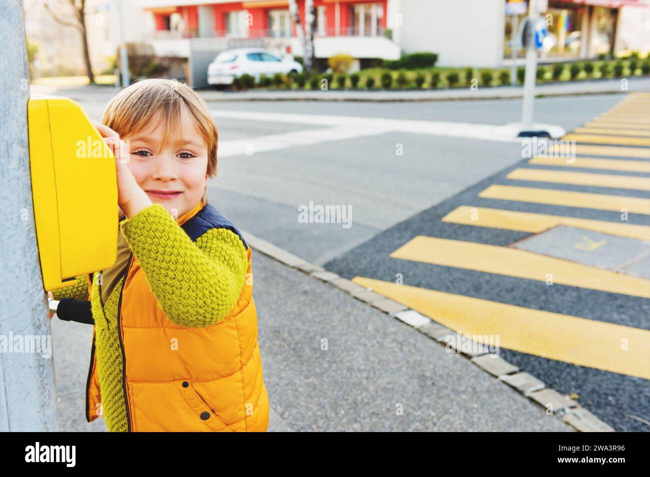 Cute little boy crossing the road alone Stock Photo - Alamy