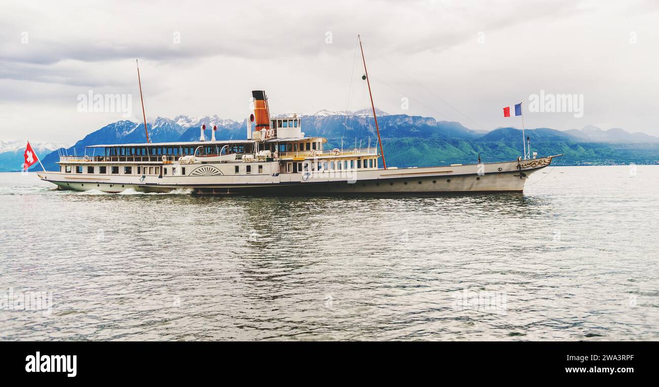 Steam boat with swiss and french flags floating on Lake Geneva or Lac ...