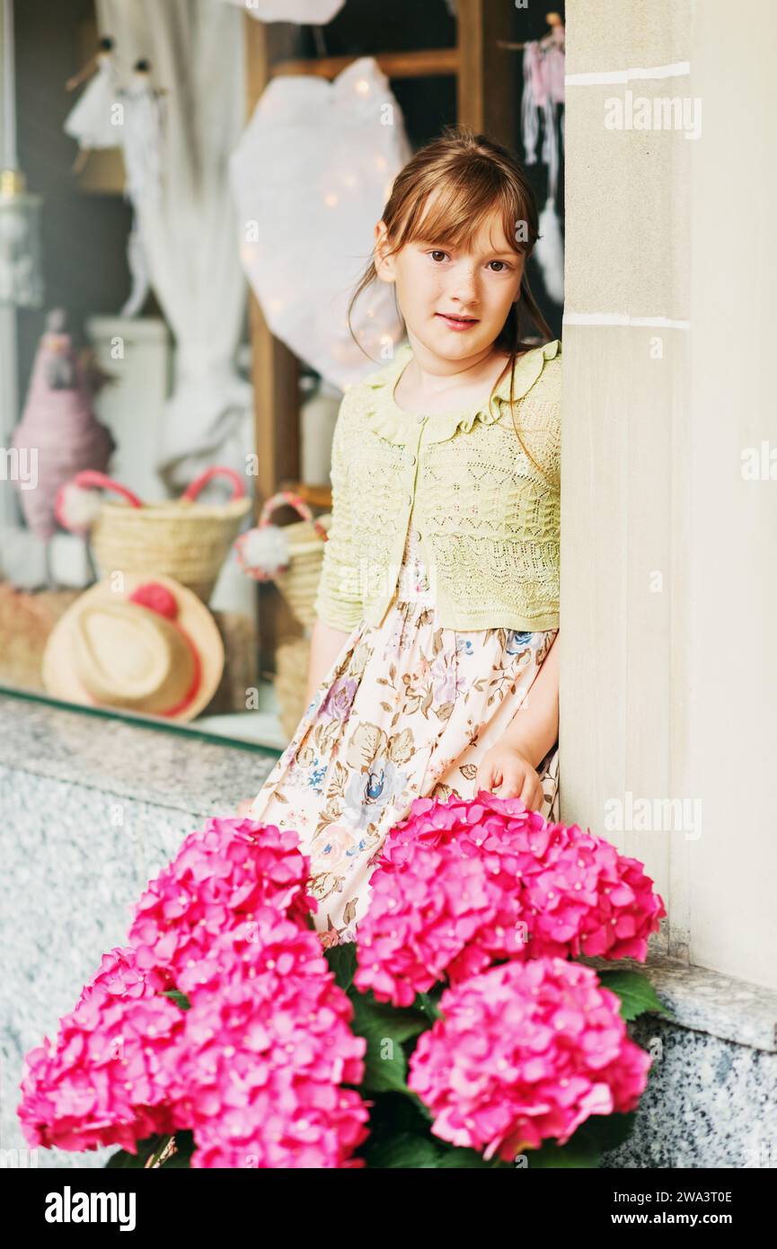 Outdoor portrait of pretty 9-10 year old girl, wearing summer dress ...