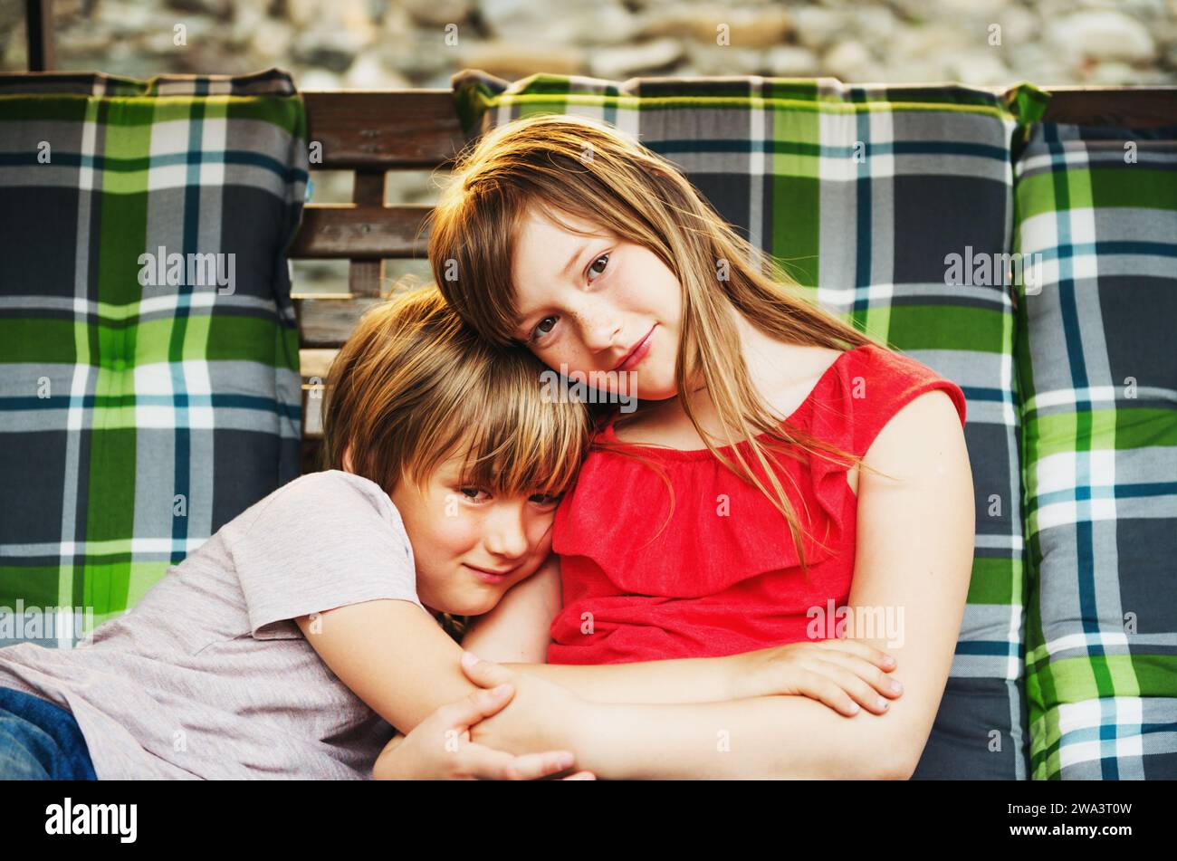 Two happy and joyful kids resting on swing bench Stock Photo - Alamy