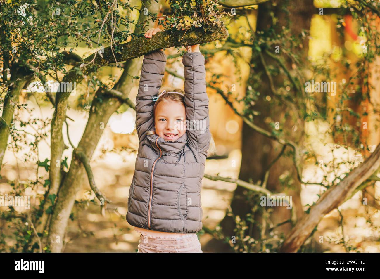 Outdoor portrait of cute little kid girl playing in the park, child ...