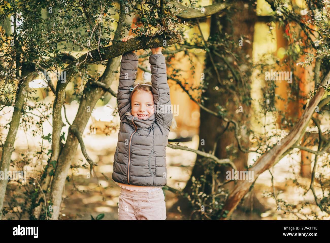 Outdoor portrait of cute little kid girl playing in the park, child ...