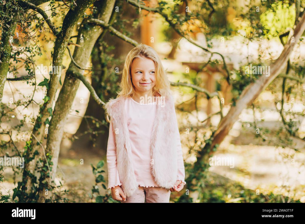 Outdoor portrait of cute little kid girl playing in the park, child ...