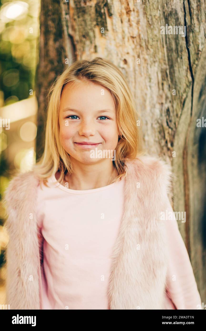 Outdoor portrait of adorable little 7 year old girl, blond hair, blue ...
