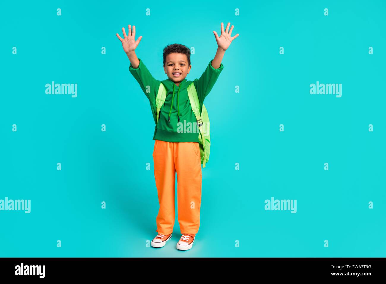 Full length photo of smart schoolboy with wavy hair dressed green ...