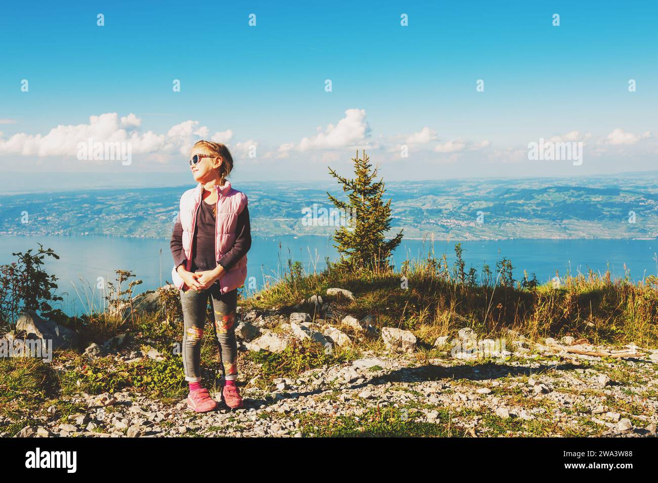 Cute little girl resting on the top of the mountain in french Alps with ...