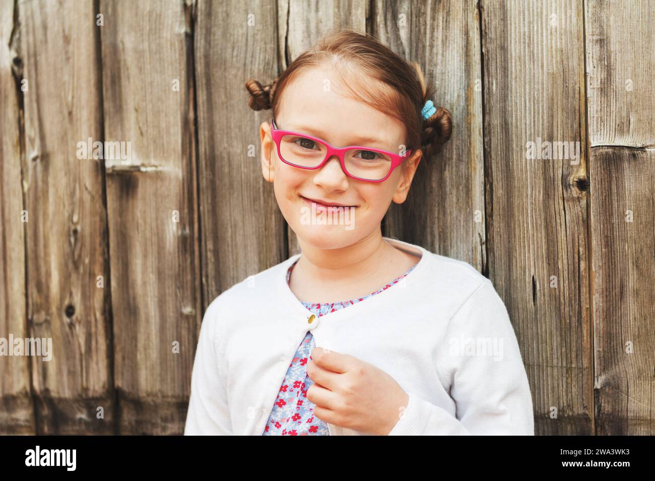 Outdoor portrait of a cute little girl wearing glasses Stock Photo - Alamy