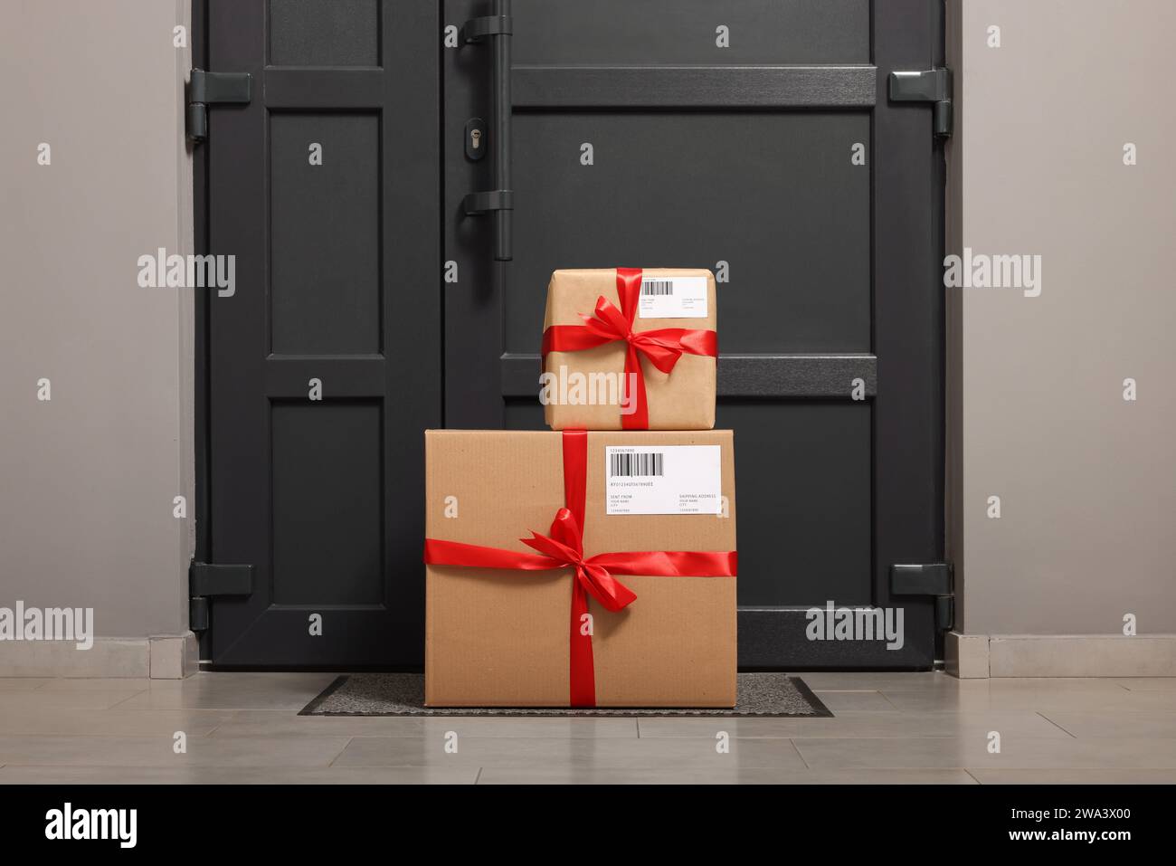 Christmas gift boxes on floor near door. Sending present by mail Stock ...