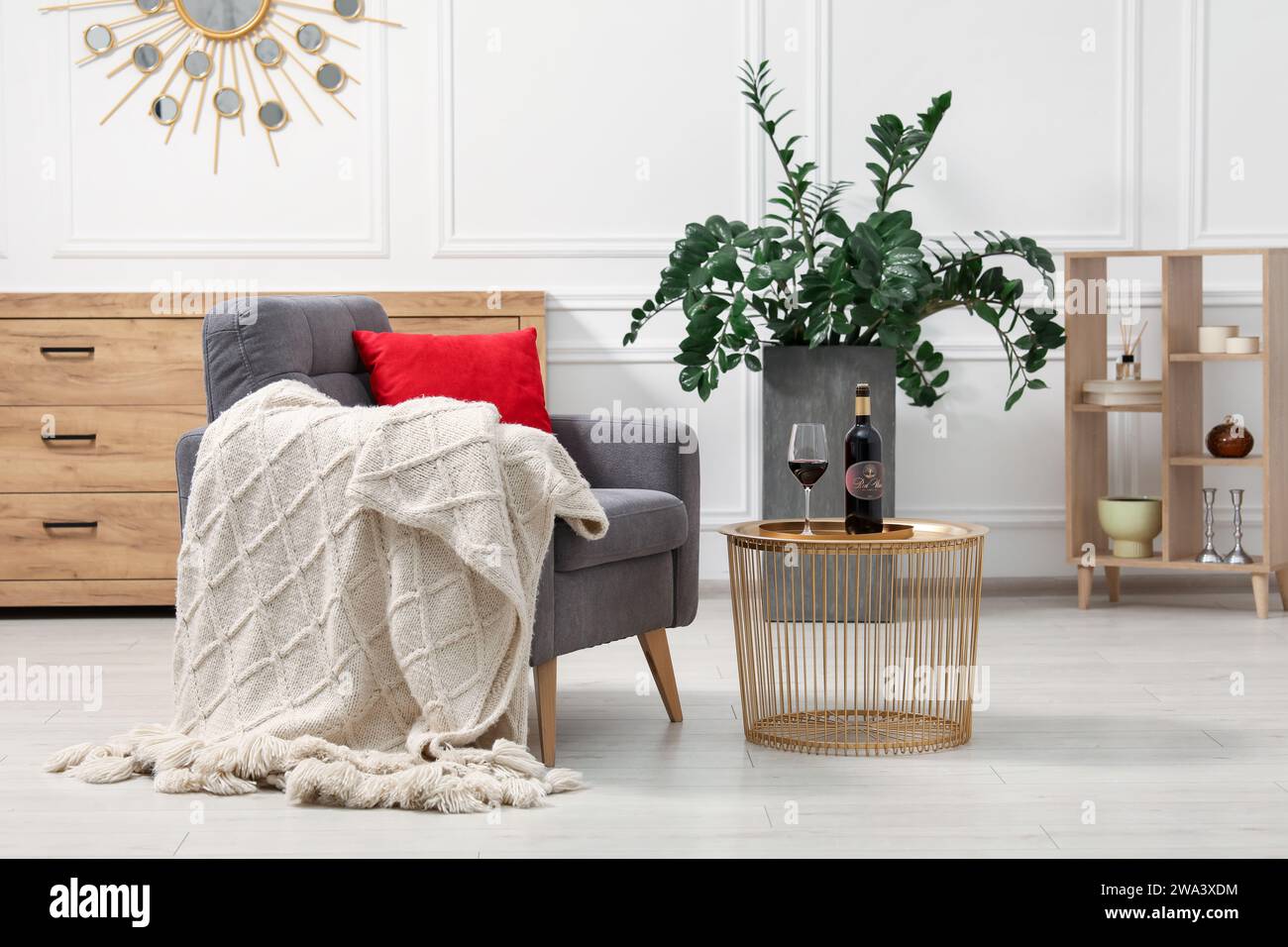 Stylish living room interior with comfortable armchair, blanket, side ...