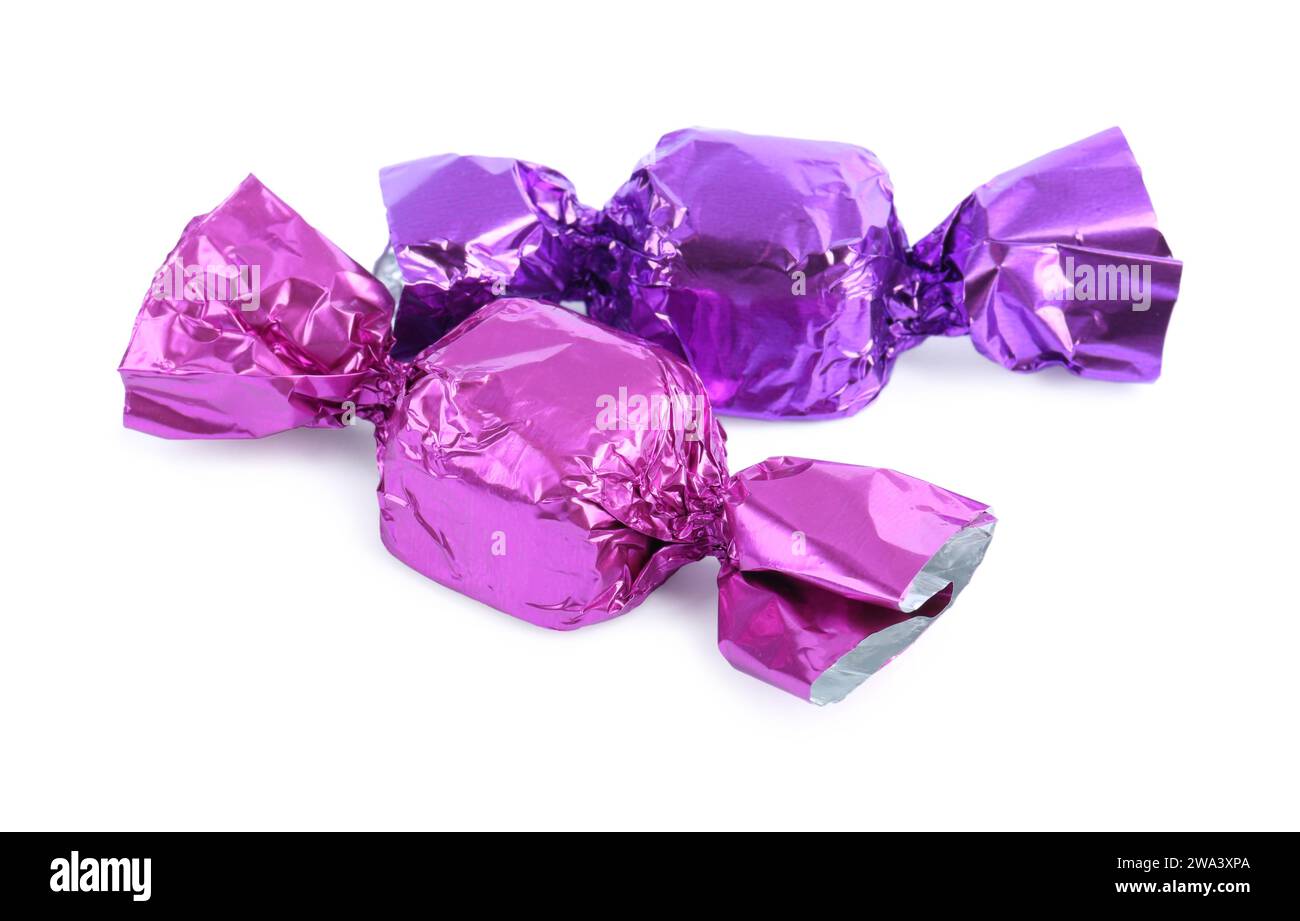 Two candies in colorful wrappers isolated on white Stock Photo - Alamy