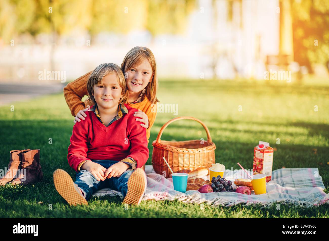 Kids eating snacks outside. Children resting in the park on a nice ...