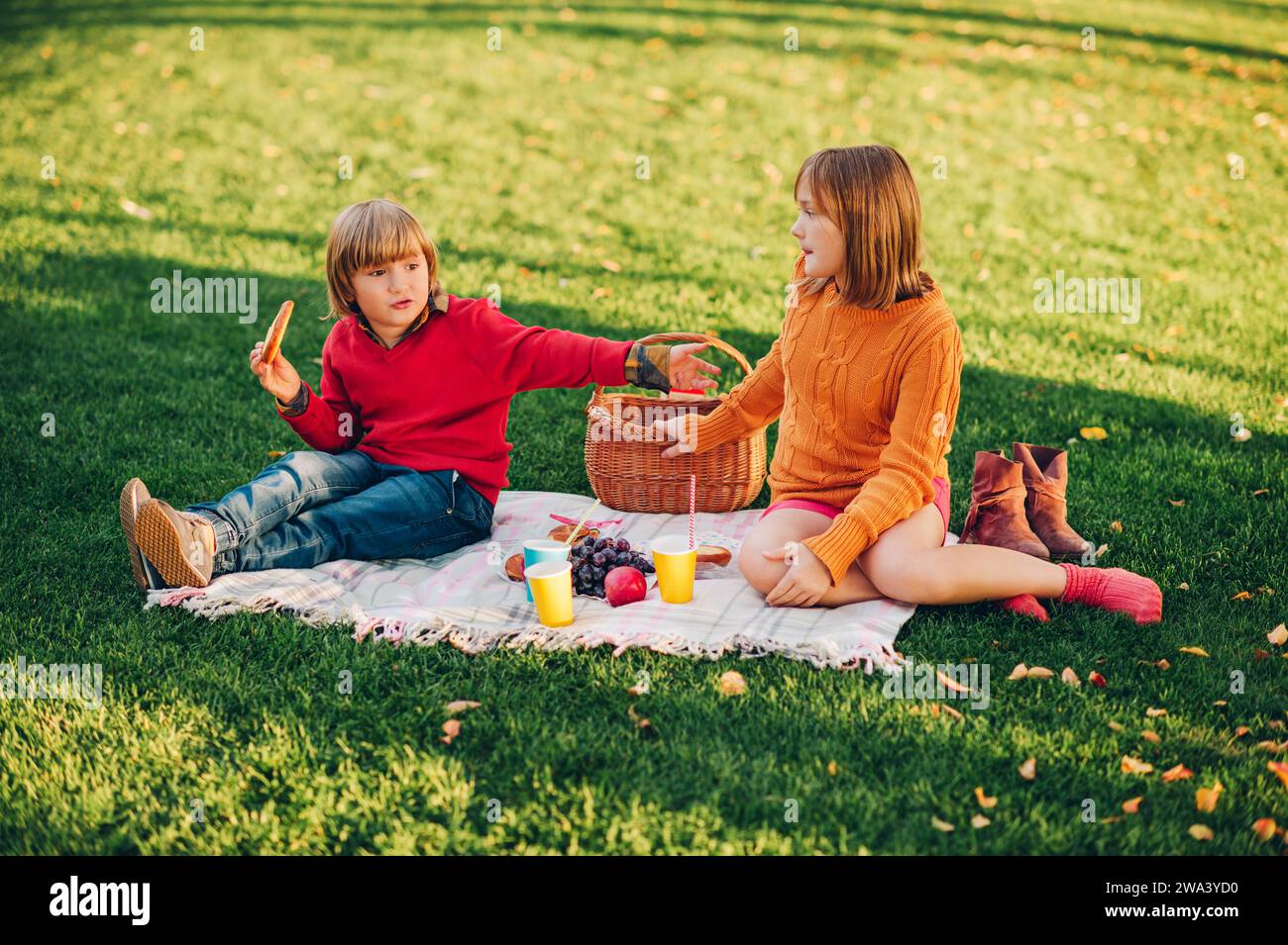 Kids eating snacks outside. Children resting in the park on a nice ...