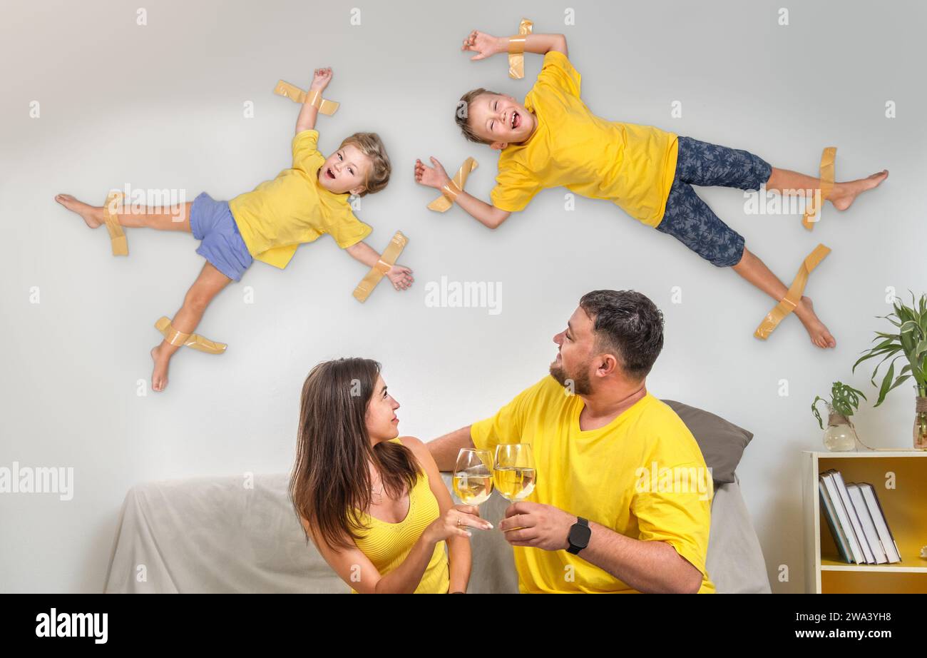 Family in the hall. Parents are sitting on the sofa with wine, and the ...