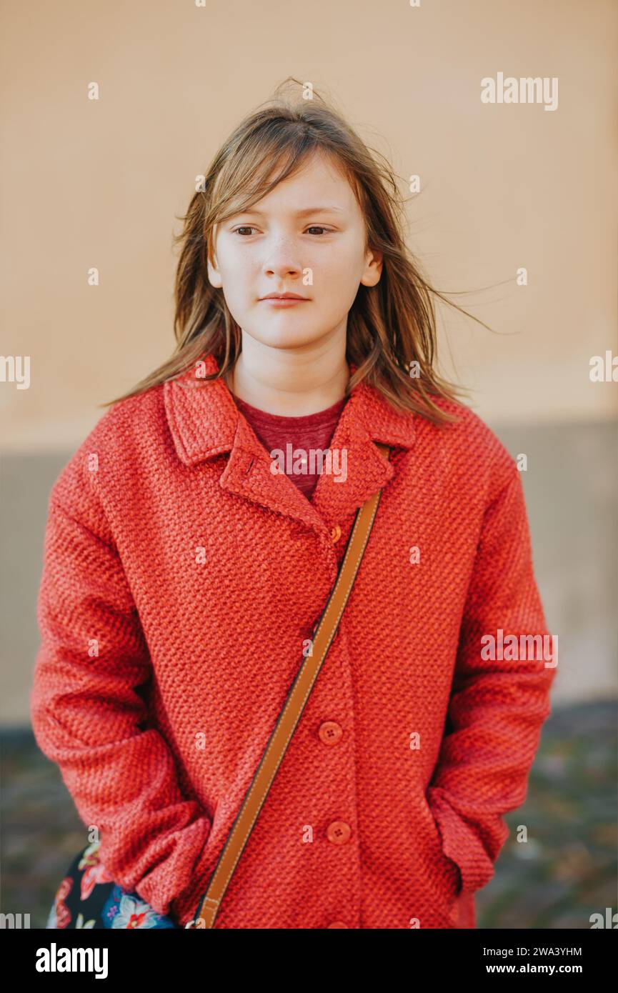 Outdoor portrait of cute teen girl wering red coat, fashion for ...