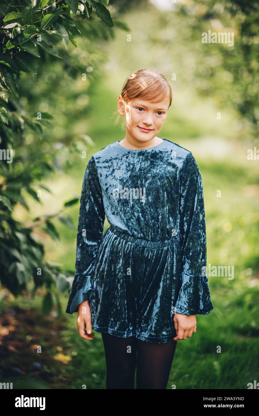 Outdoor portrait of beautiful little 10 year old girl wearing blue ...