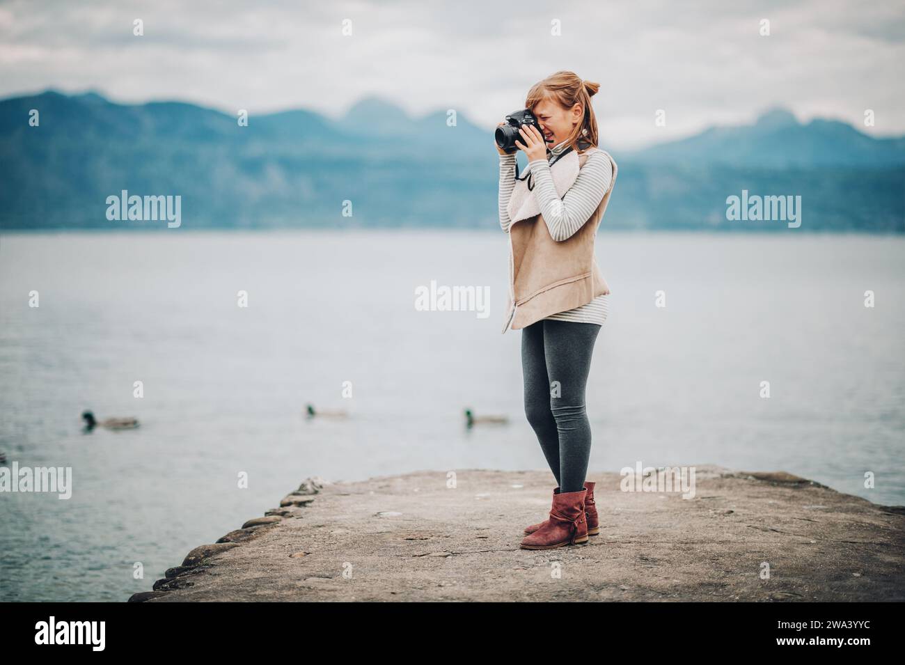 Cute little preteen girl enjoying nice day on lake Geneva, taking ...
