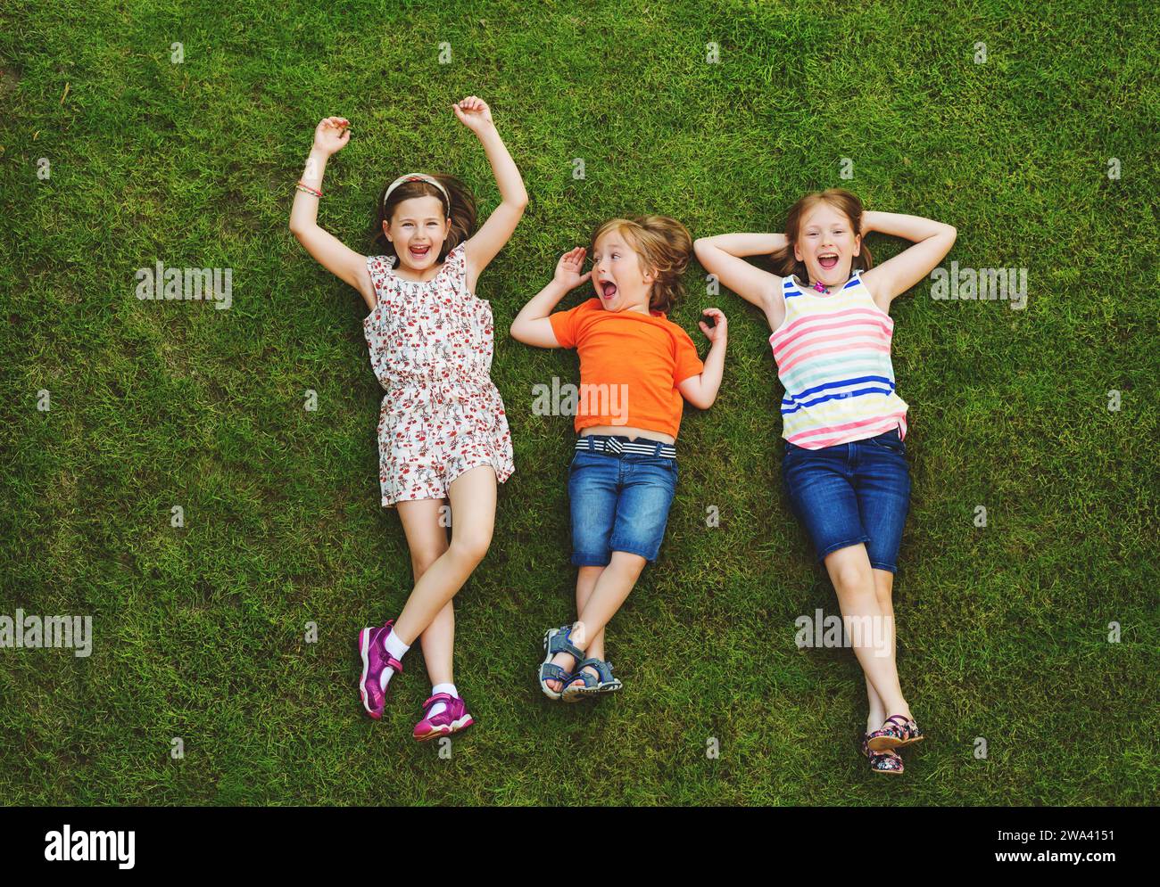 Happy children having fun outdoors. Kids playing in summer park. Little ...