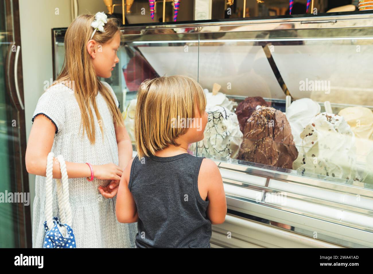 Sweet little kids choosing dessert in ice cream shop Stock Photo - Alamy