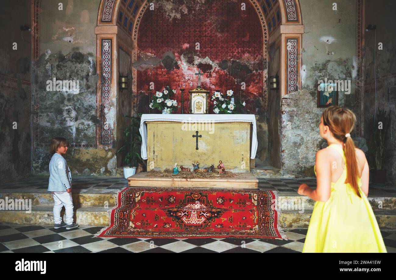 Little boy and girl visiting old italian church during Tuscany trip ...