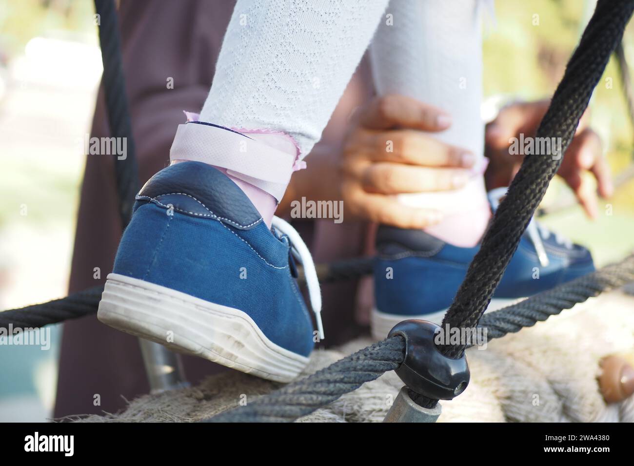 Child cerebral palsy disability, legs orthosis Stock Photo - Alamy