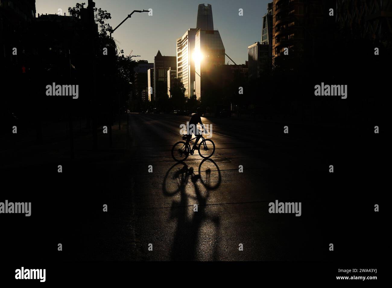Santiago, Metropolitana, Chile. 1st Jan, 2024. A man rides a bicycle at ... Santiago, Metropolitana, Chile. 1st Jan, 2024. A man rides a bicycle at ...