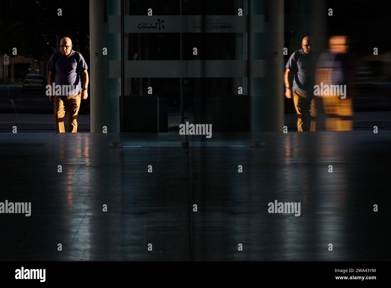 Santiago, Metropolitana, Chile. 1st Jan, 2024. A man is reflected in a ... Santiago, Metropolitana, Chile. 1st Jan, 2024. A man is reflected in a ...