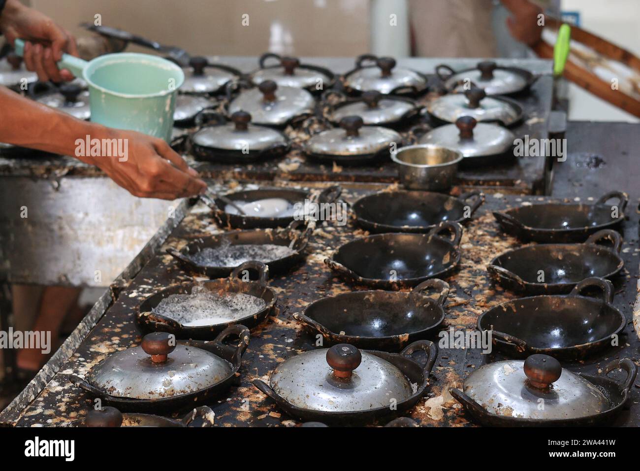 Male Hand Making Srabi Notosuman, Pour Coconut Rice Flour Batter to the ...