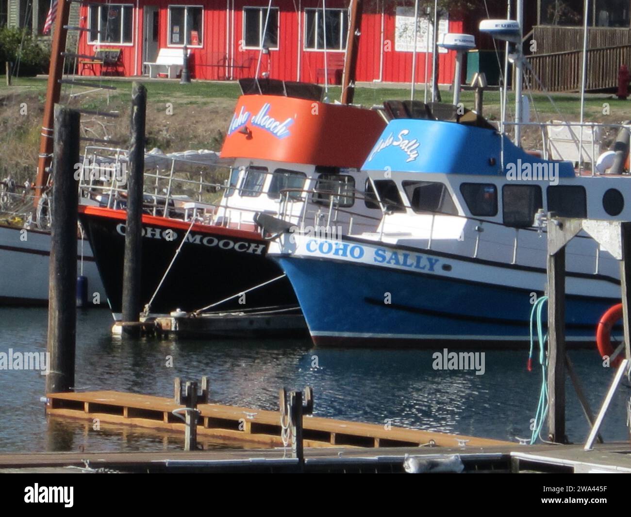 Colorful local fishing boats docked in the Ilwaco marina, Washington ...