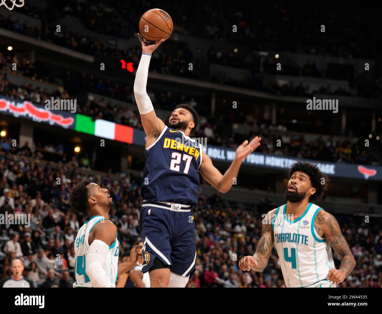 Denver Nuggets guard Jamal Murray, center, drives to the rim between ...