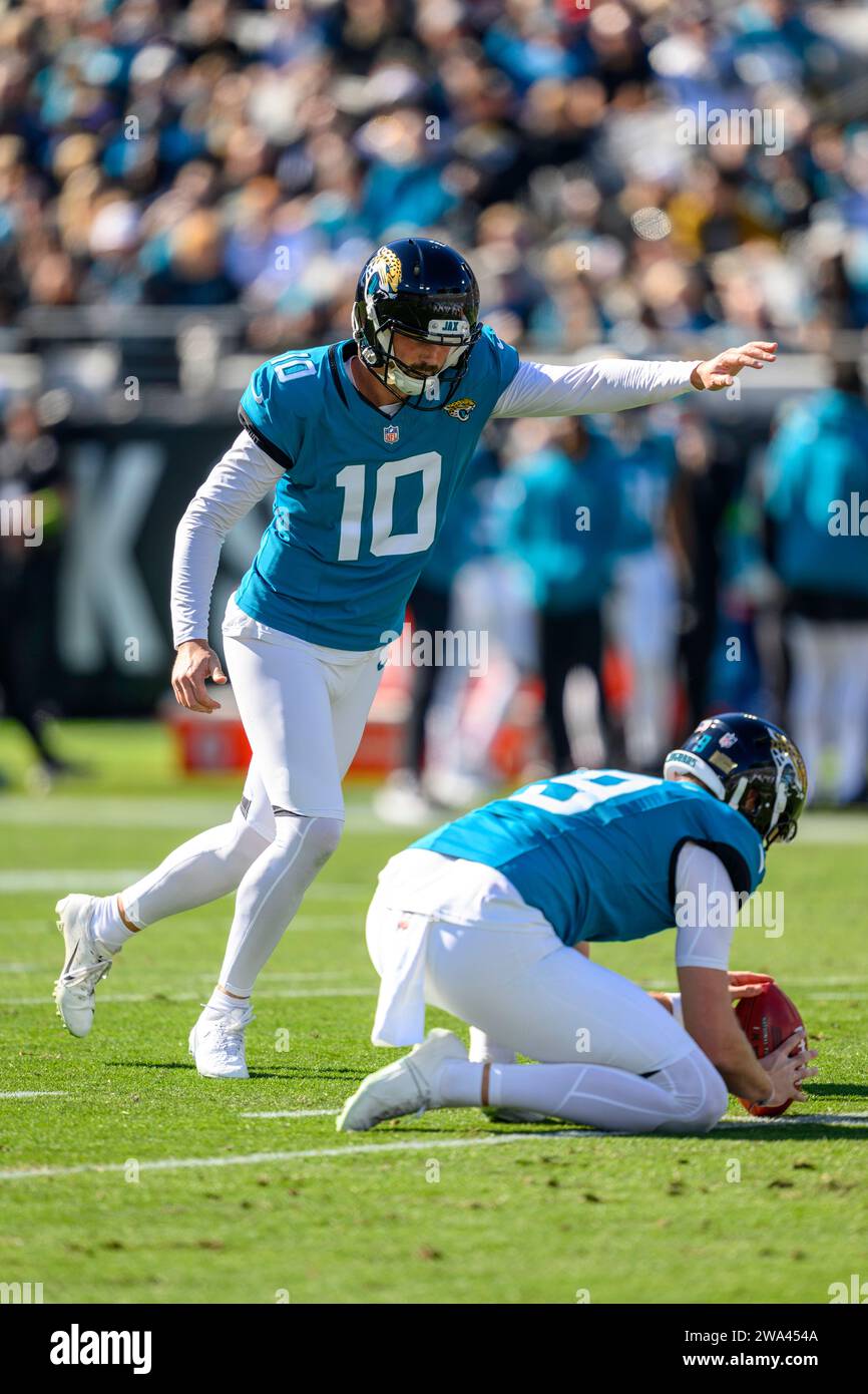 Jacksonville Jaguars punter Logan Cooke (9) holds the ball as kicker ...