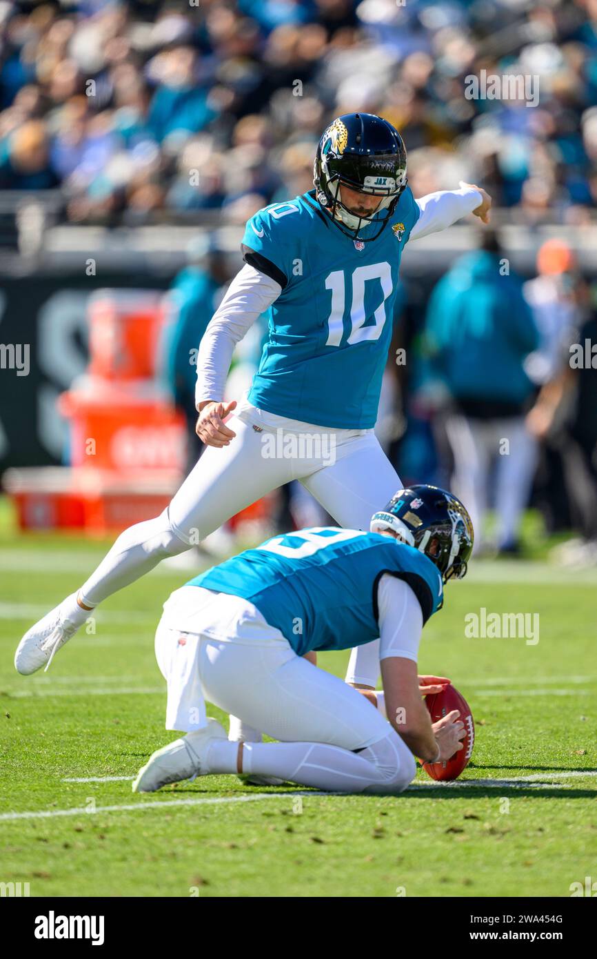 Jacksonville Jaguars punter Logan Cooke (9) holds the ball as kicker ...