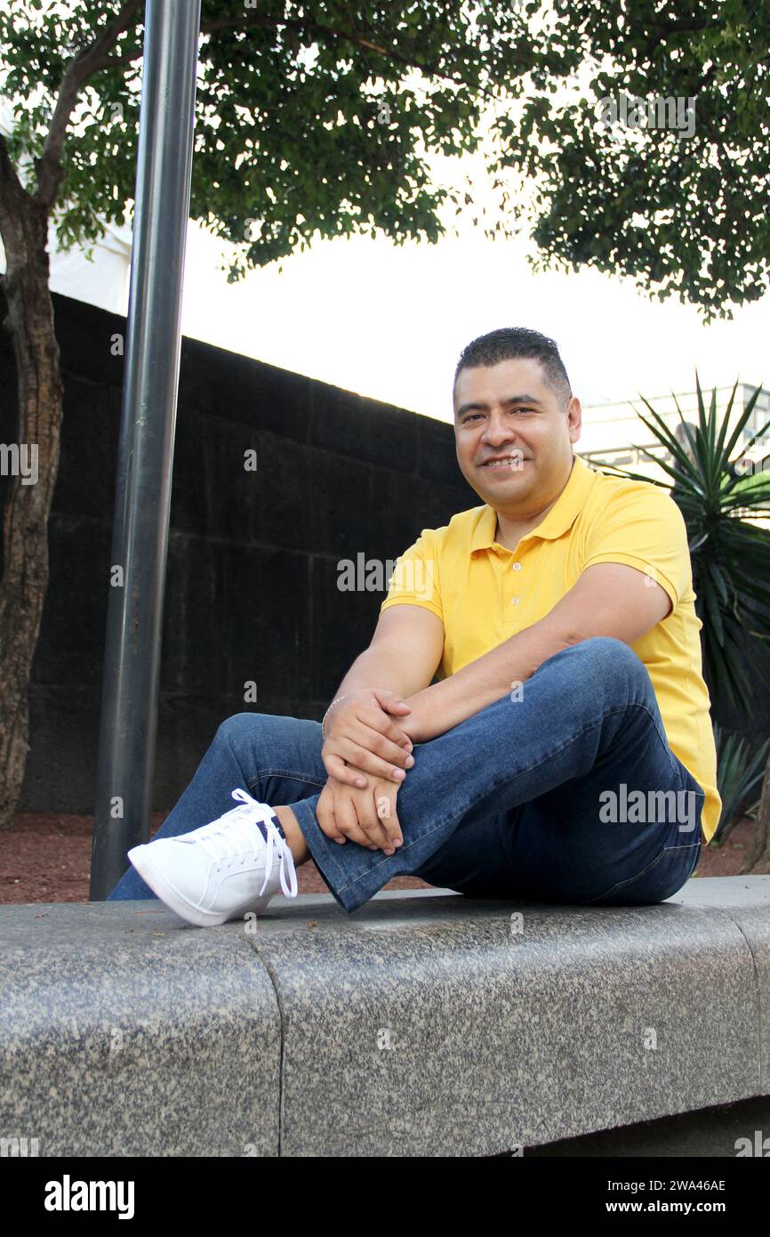 40-year-old dark-skinned Latin man relaxed and calm enjoys the day ...