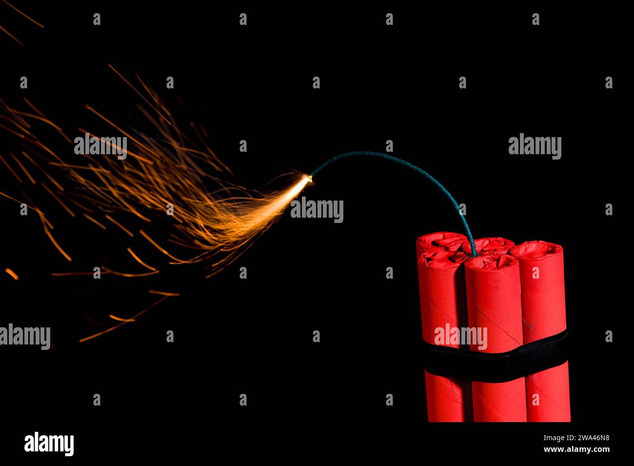A bundle of dynamite with lit fuse again black background Stock Photo ...