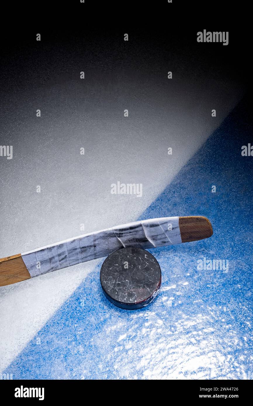 Looking down on an ice hockey puck and stick at the blue line Stock ...