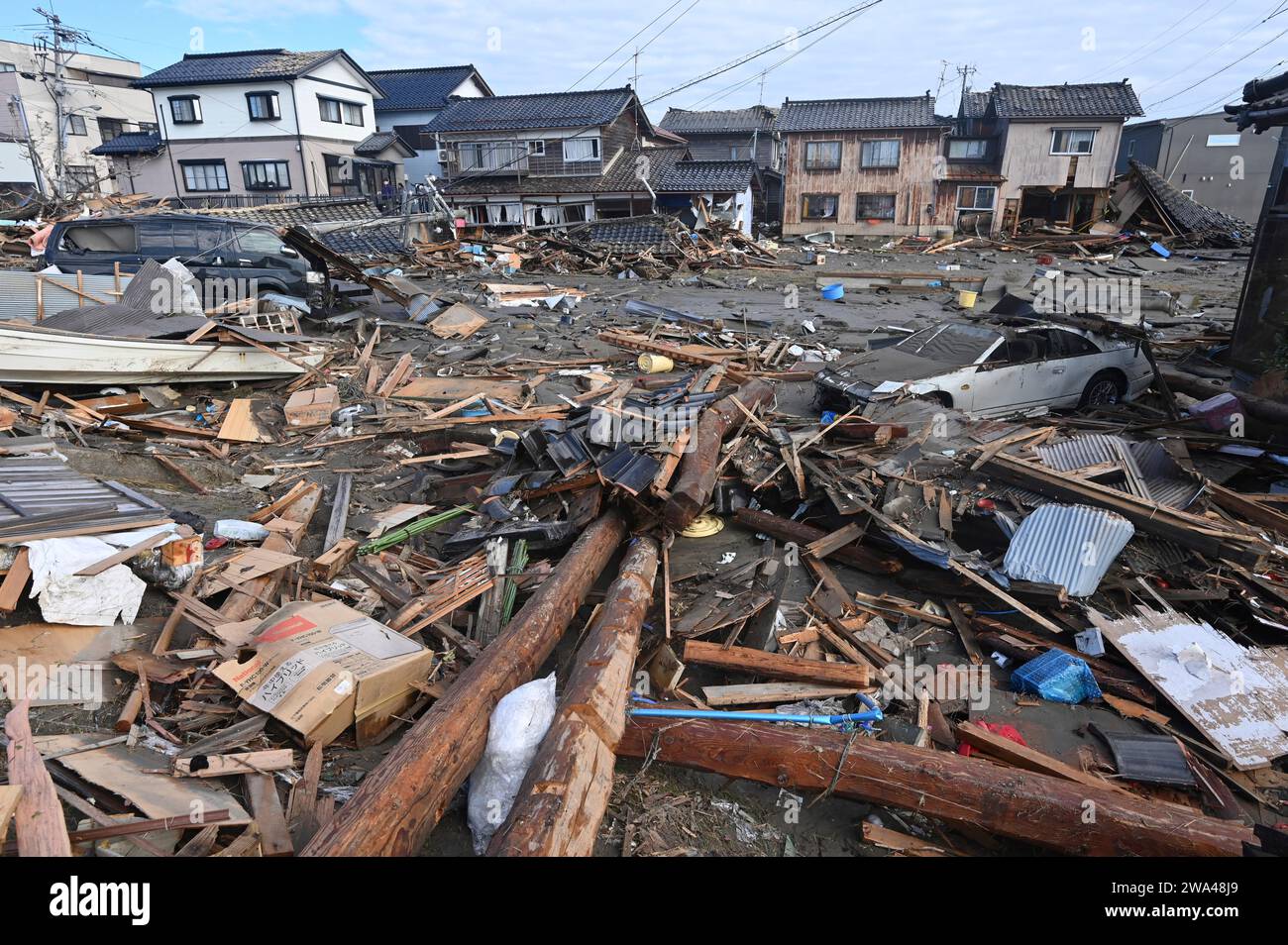 A car and houses are washed awary by a strong tsunami occurred in Suzu ...