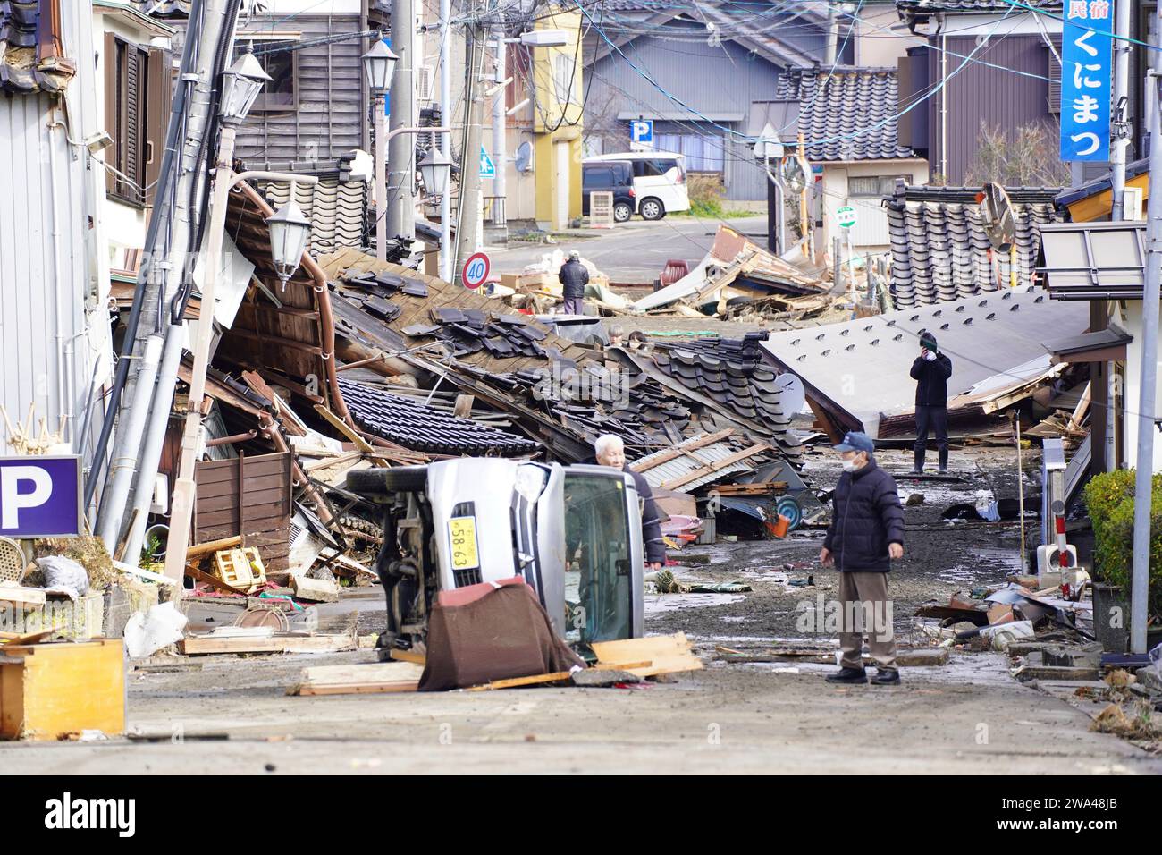 A car and houses are washed awary by a strong tsunami occurred in Suzu ...