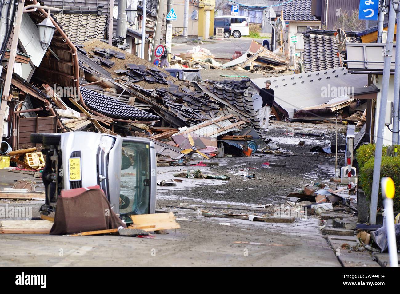 A car and houses are washed awary by a strong tsunami occurred in Suzu ...