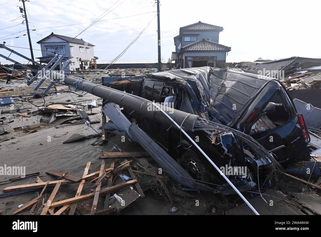 A car is crushed by a fallen utility pole as a strong tsunami occurred ...