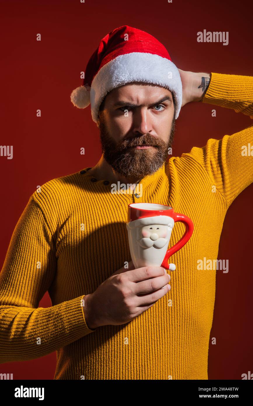 Santas face. Christmas man in Santa hats on red studio background ...